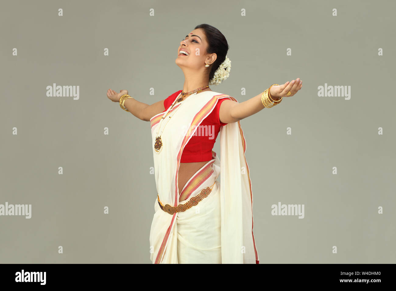South Indian woman standing with her arm outstretched Stock Photo - Alamy
