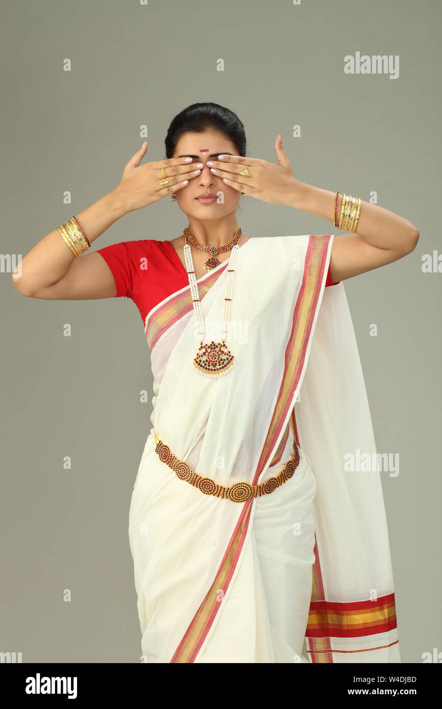 South Indian woman covering eyes with hands Stock Photo - Alamy