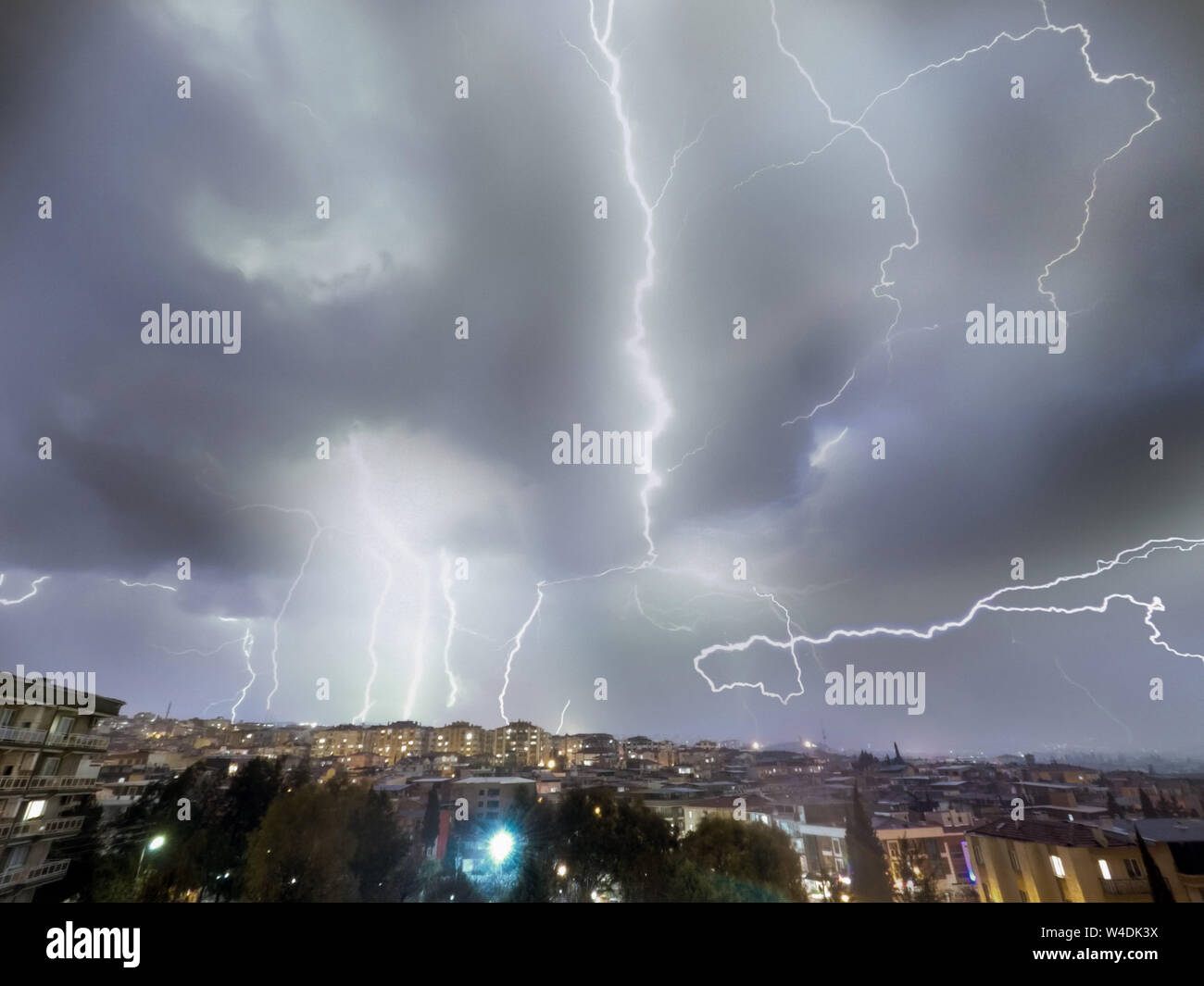 Lightning striking over city buildings hi-res stock photography and ...
