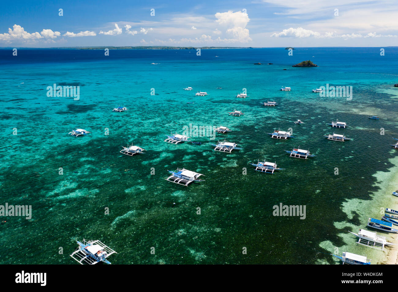 Aerial view of traditional Bangka boats moored above a large tropical ...