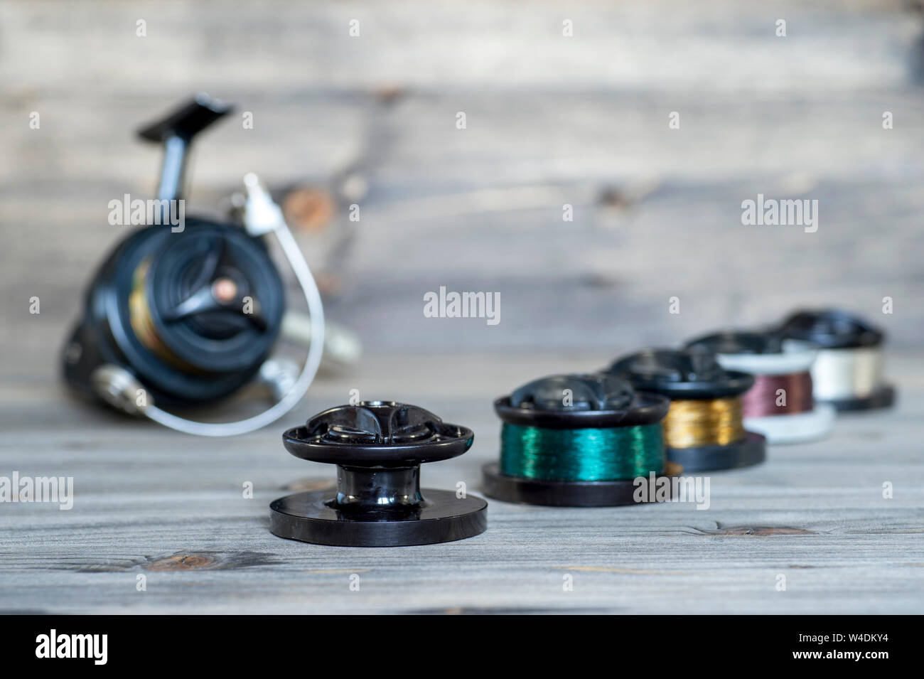 Set with multi-colored spools with fishing line for fishing on the ...