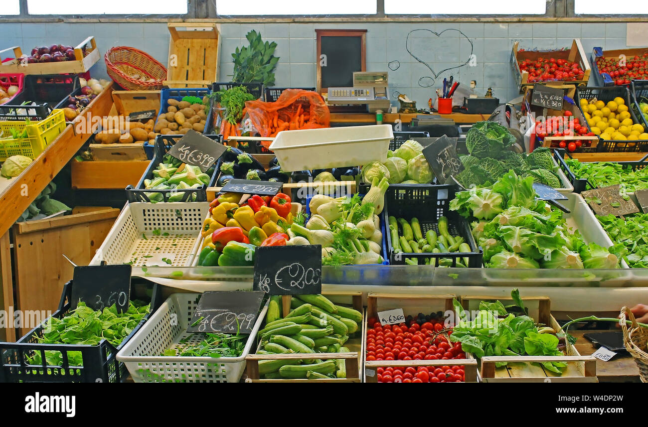 Large market stall with fresh organic vegetables piles in wooden and ...