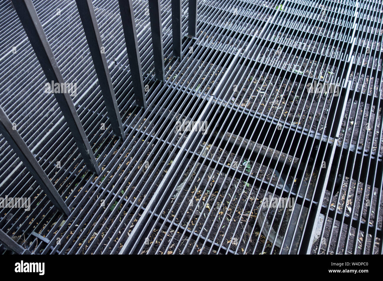 Outside metal stairs framework with handrail. Steps from iron straps ...