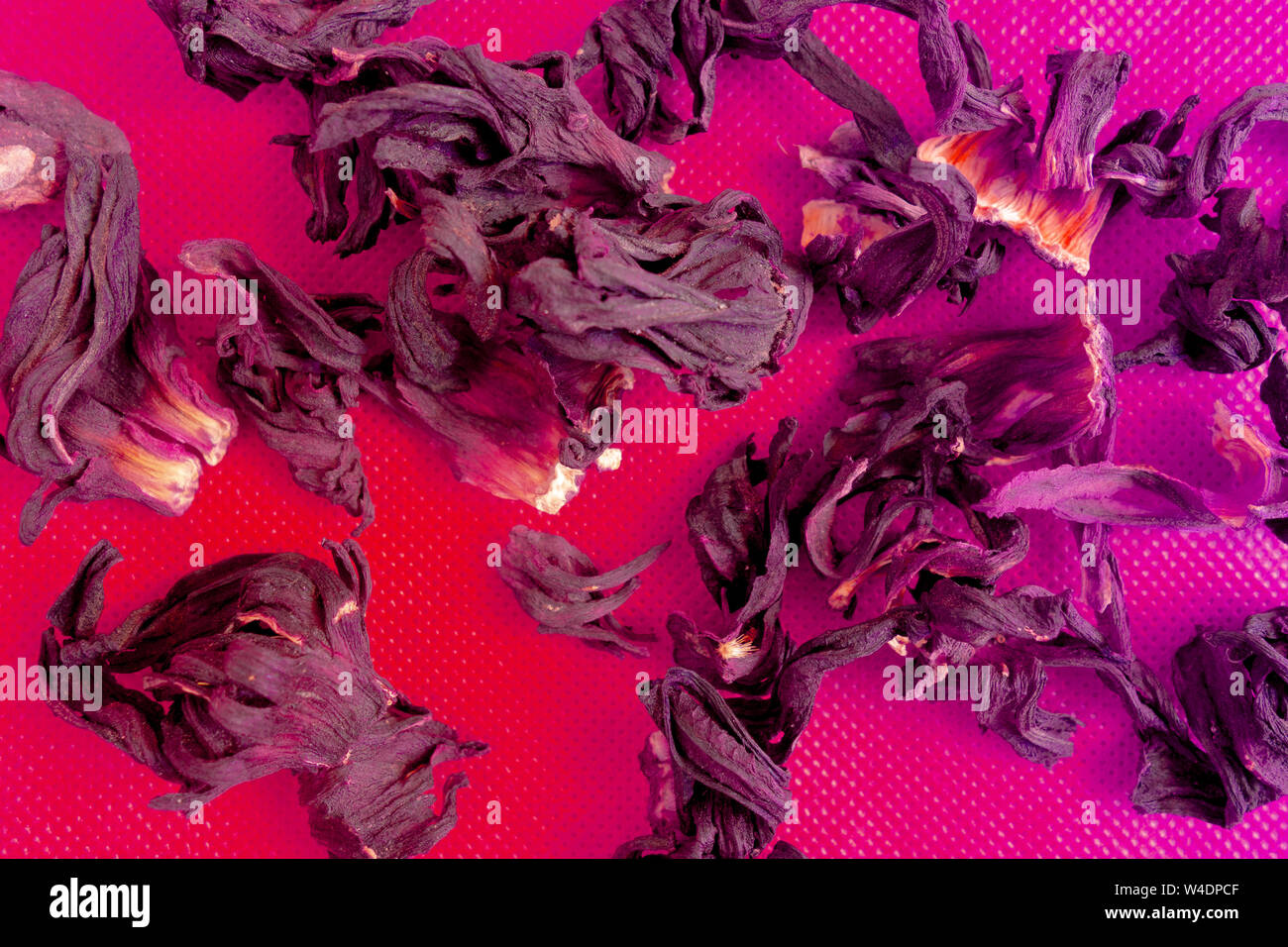 Dried herbal flower particles macro background. Red and pink colors ...