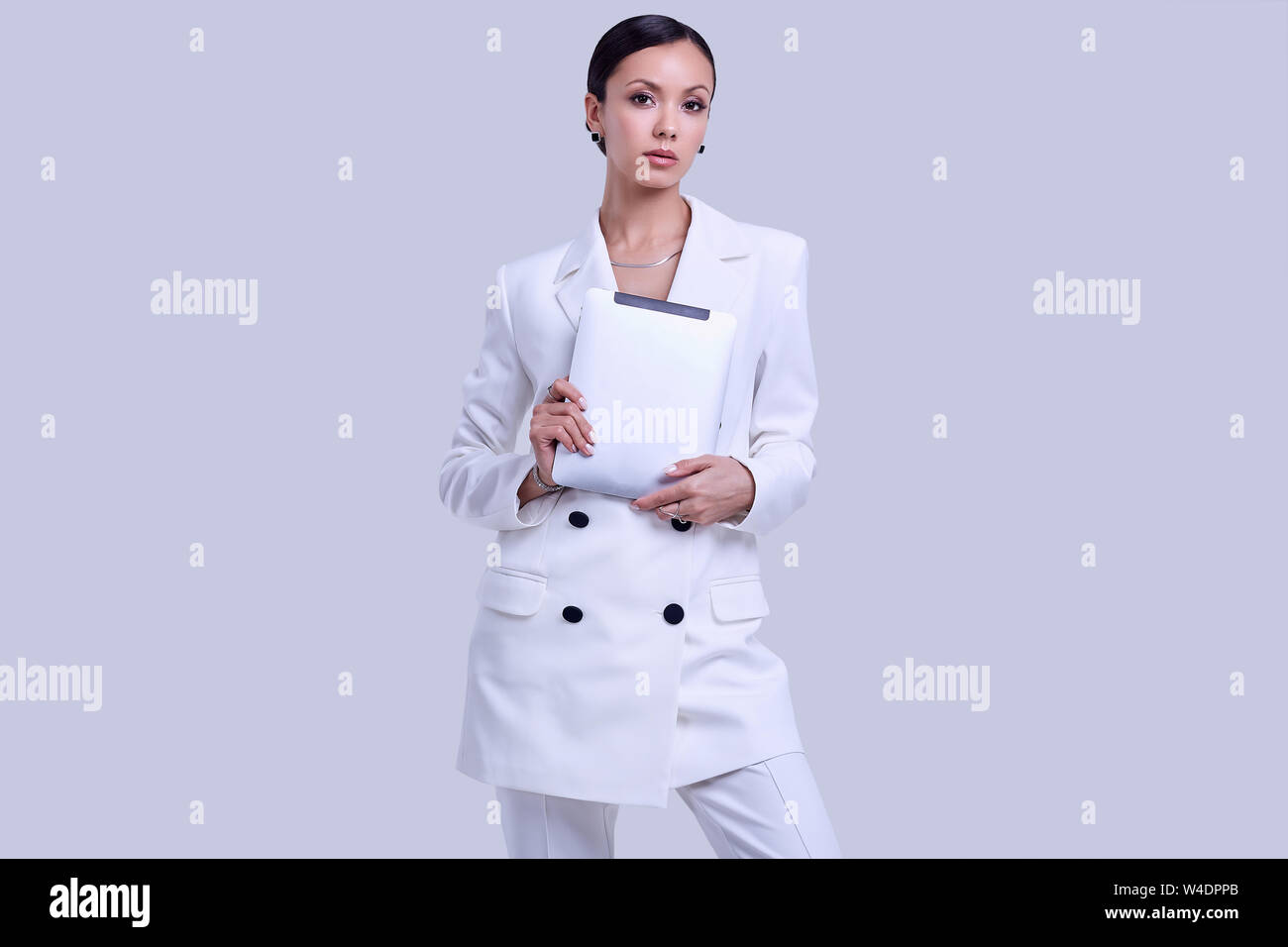 Portrait of a cute and gorgeous latin women in fashion white suit with ...