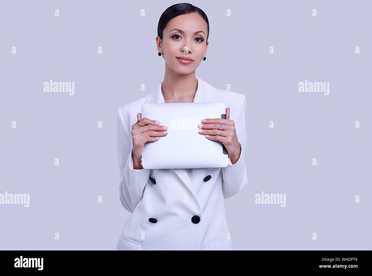 Portrait of a cute and gorgeous latin women in fashion white suit with ...