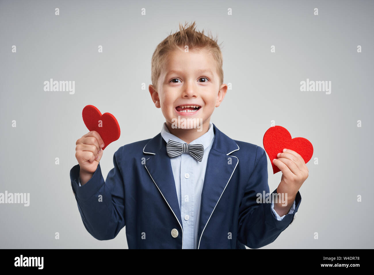 Portrait of happy cute little kid holding red heart Stock Photo - Alamy