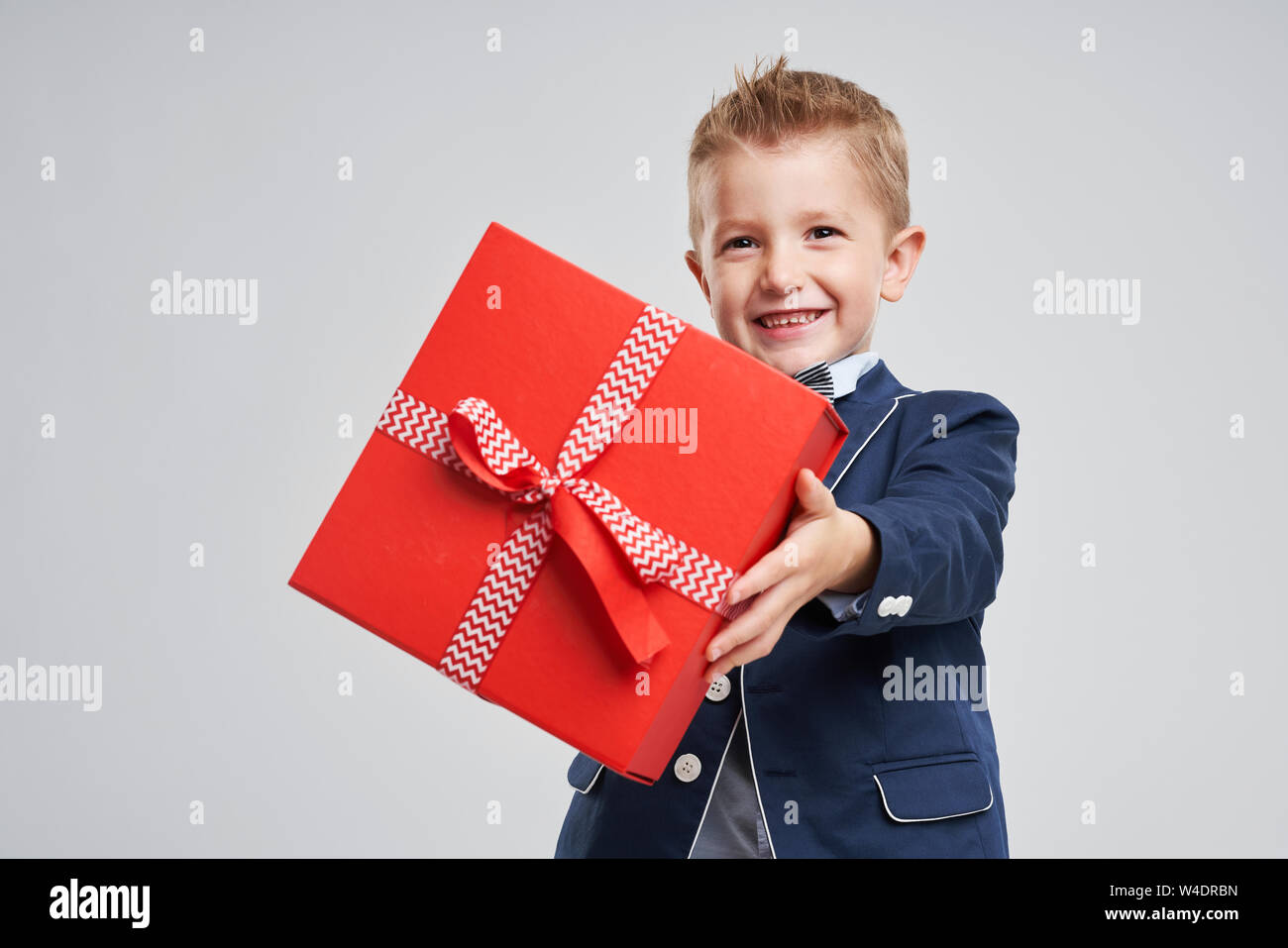 Portrait of happy cute little kid holding gift Stock Photo - Alamy
