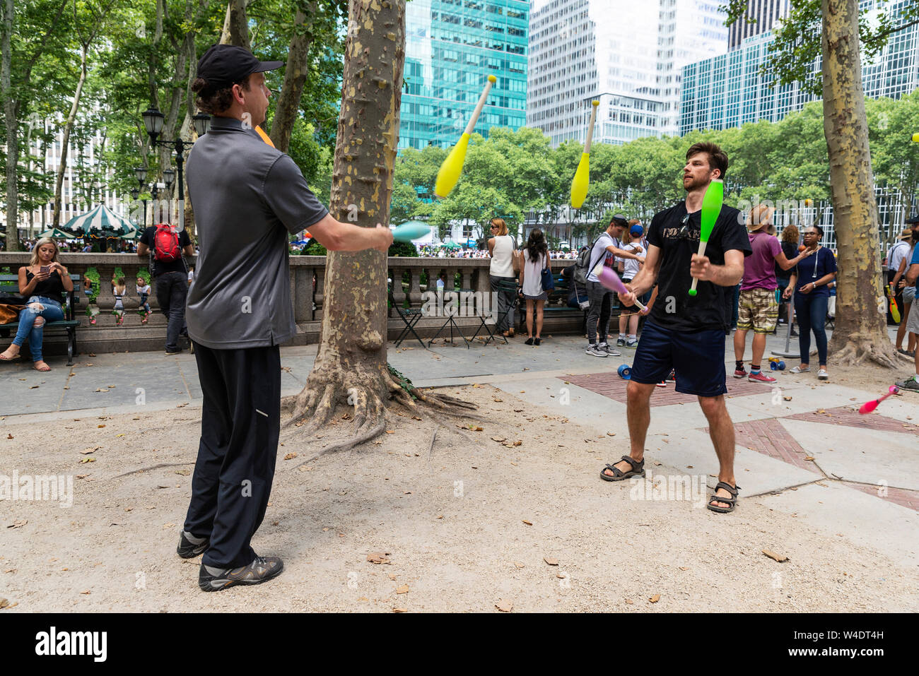 New York City, USA - August 2, 2018: Two men playing juggling in Bryant ...