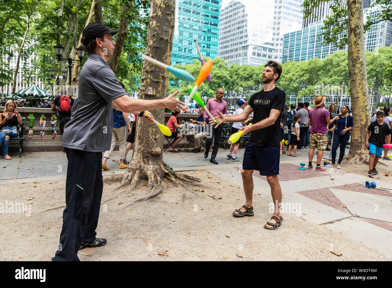 New York City, USA - August 2, 2018: Two men playing juggling in Bryant ...