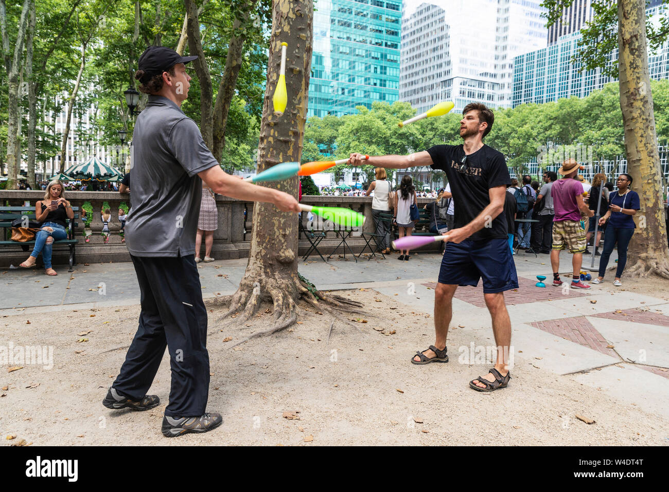 New York City, USA - August 2, 2018: Two men playing juggling in Bryant ...