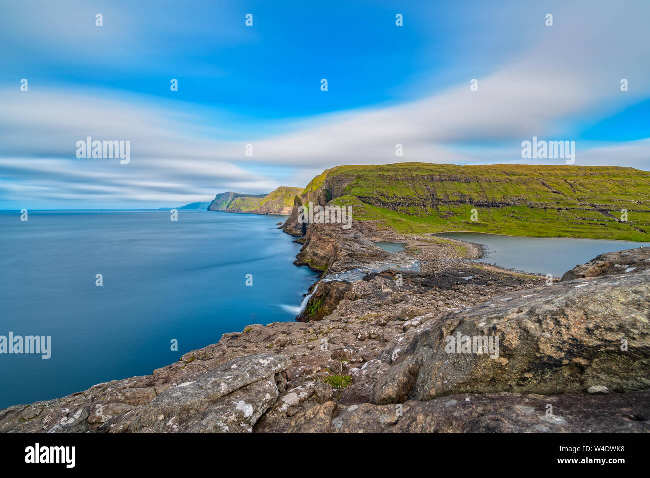 Bosdalafossur waterfall on Vagar island coastline long exposure, Faroe ...