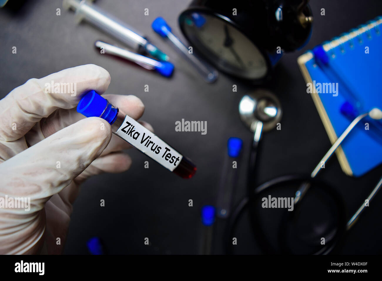 Zika Virus Test text with blood sample. Top view isolated on black ...