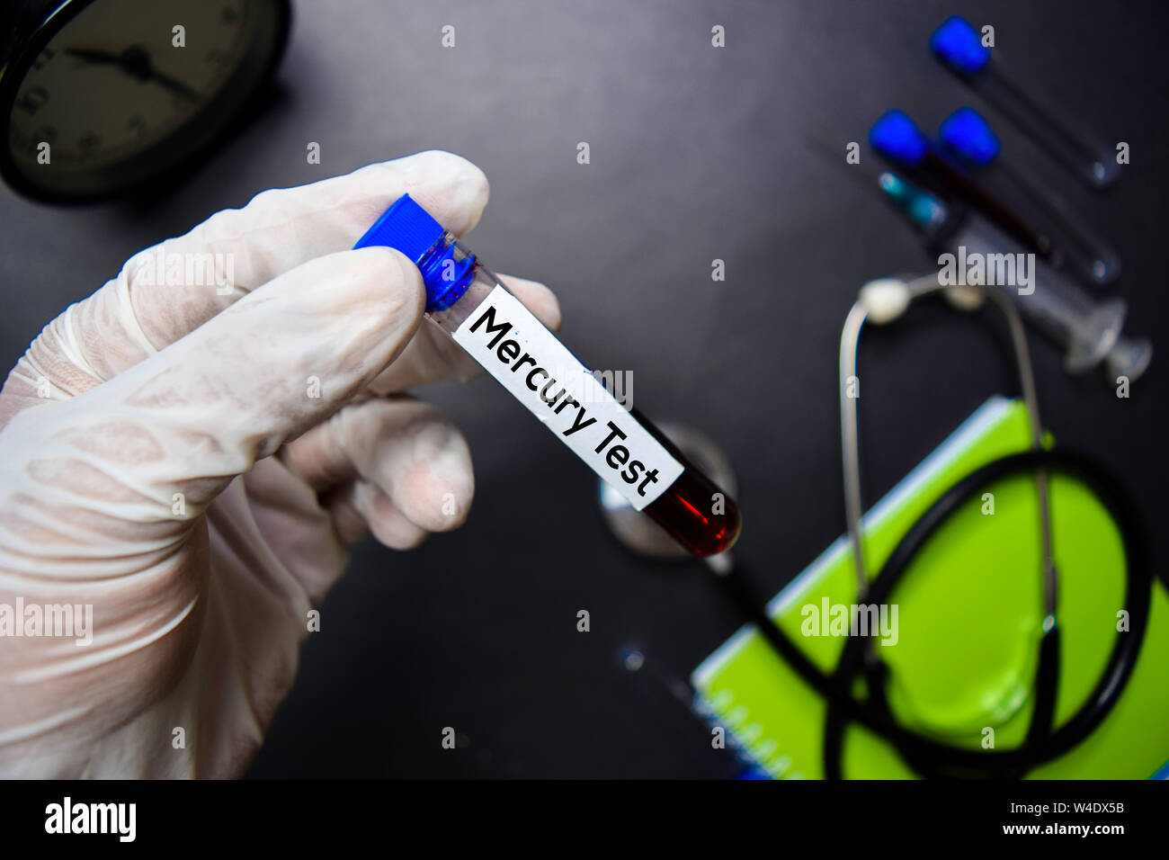 Mercury Test text with blood sample. Top view isolated on black ...