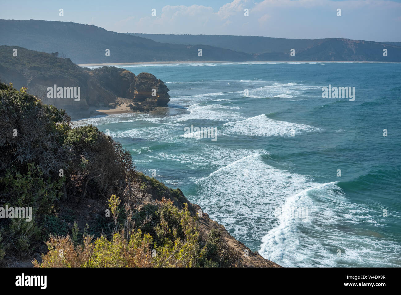 Surf's Up! Series of waves with frothy surf roll onto the shore along ...