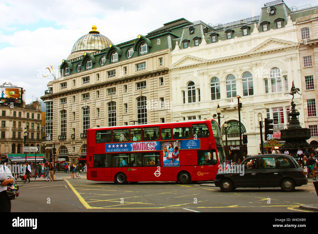 the traditional red double-decker London buses in the traffic on the ...