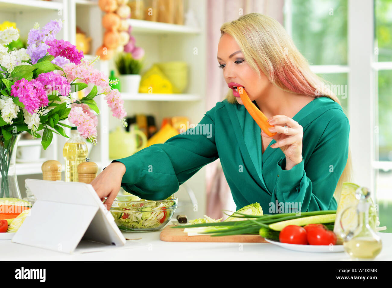 Portrait of beautiful young woman cooking in kitchen Stock Photo - Alamy