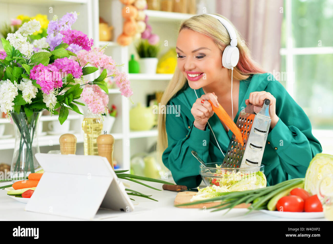 Portrait of beautiful young woman cooking in kitchen Stock Photo - Alamy