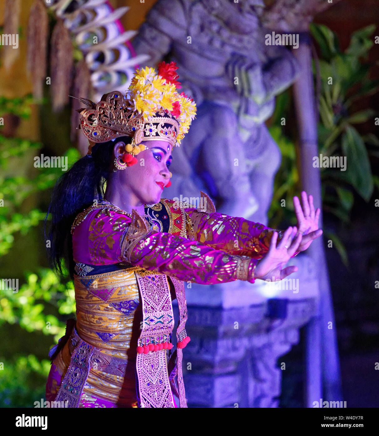 Woman Balinese dancer in traditional dress costume performing in front ...