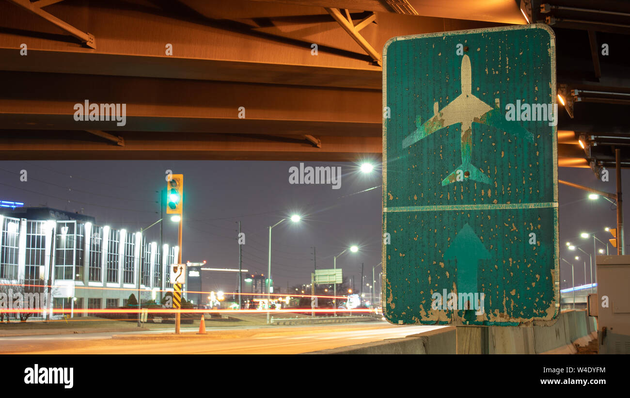 Old, worn-out green airport ahead sign in-front of Toronto Pearson ...