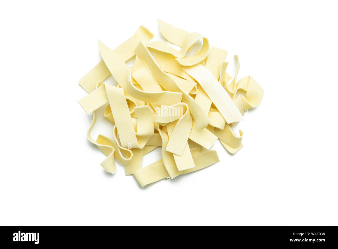 Raw tagliatelle pasta isolated on white background Stock Photo - Alamy