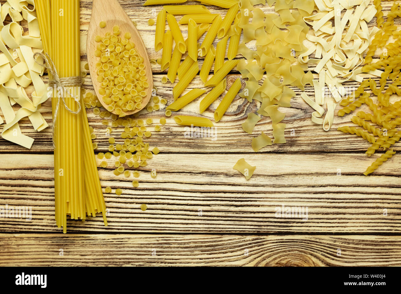 Collection of italian pasta top view on vintage wooden background Stock ...