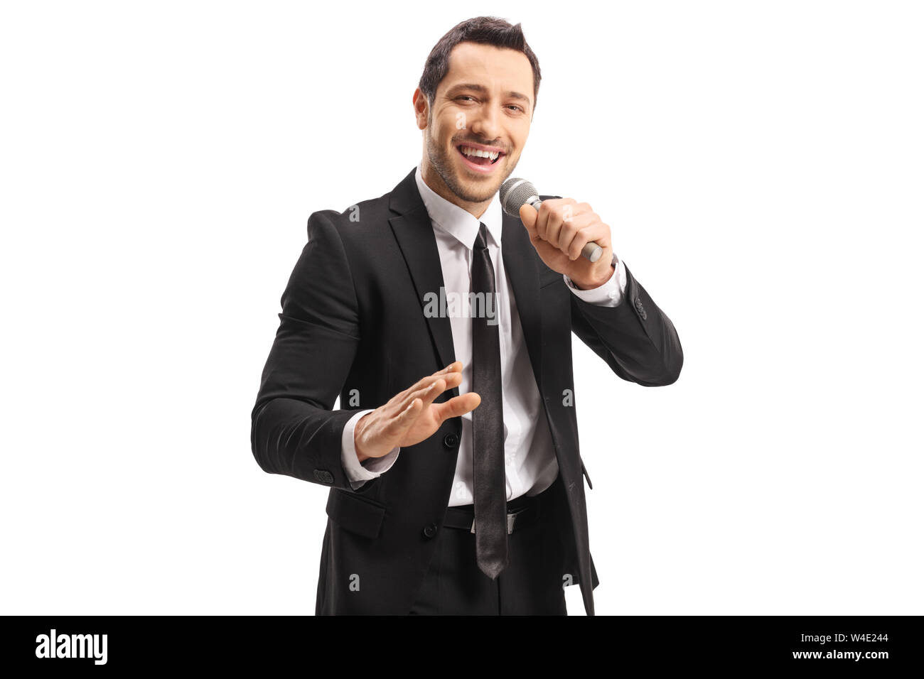 Young handsome man with a microphone in his hand isolated on white ...