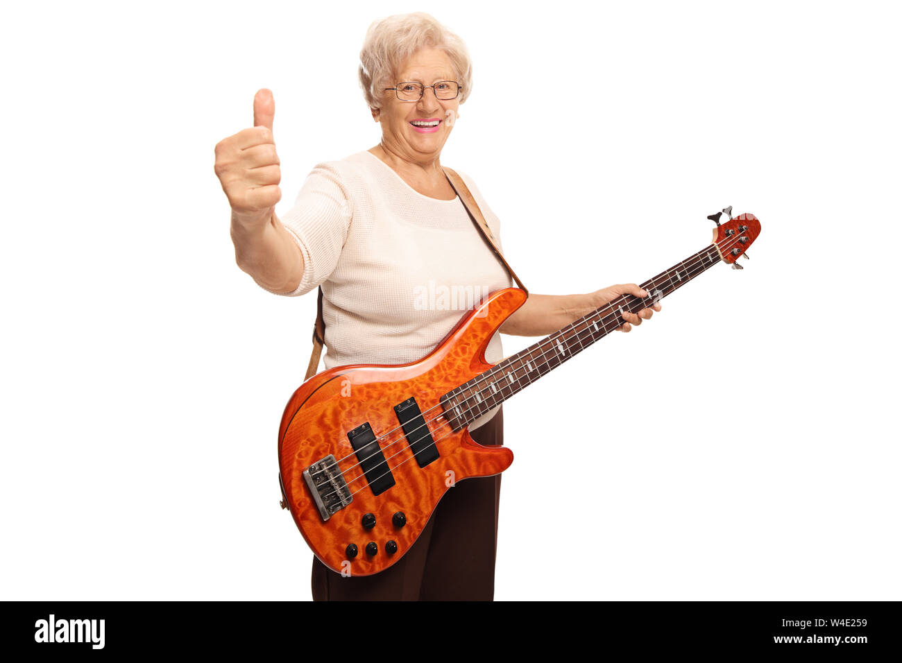 Happy senior woman with an electric guitar showing thumbs up isolated ...