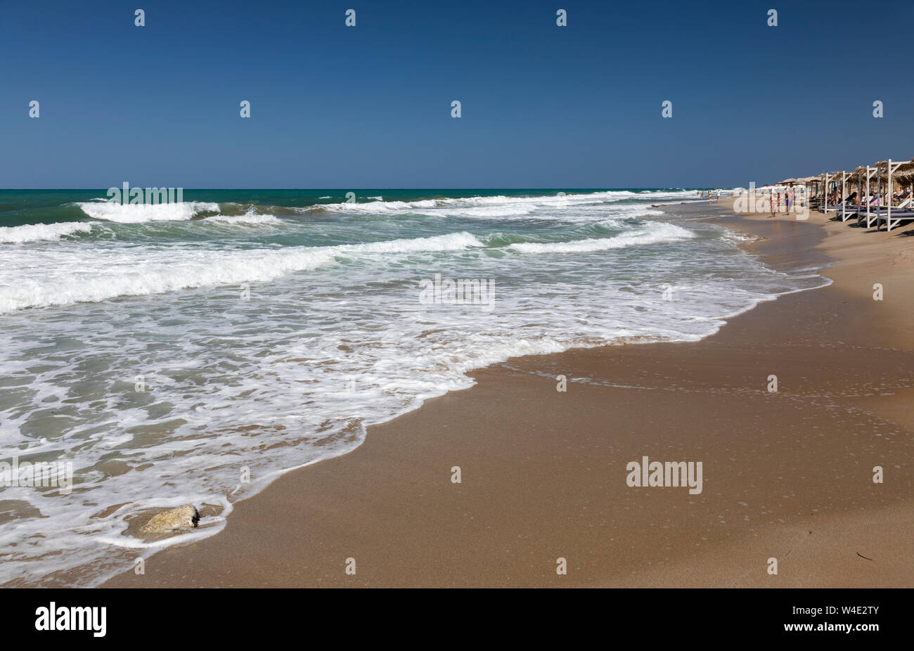 Holidaymakers enjoying the sandy beach at Analipsi, Crete, Greece Stock ...