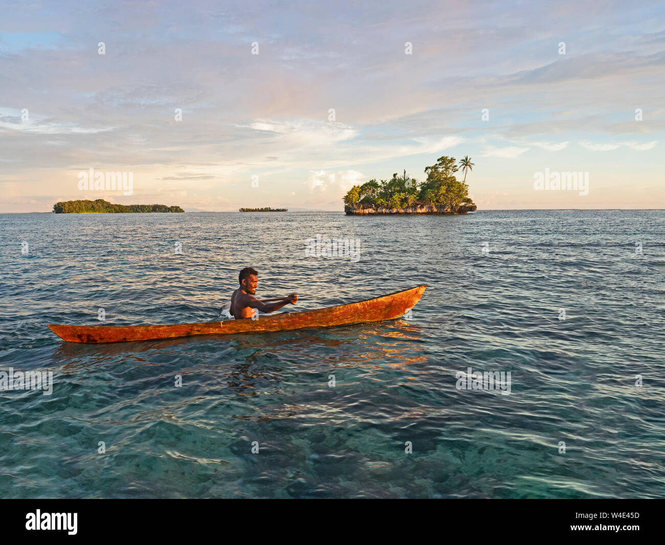 Island and local fisherman in dug out canoe in New Georgia group ...