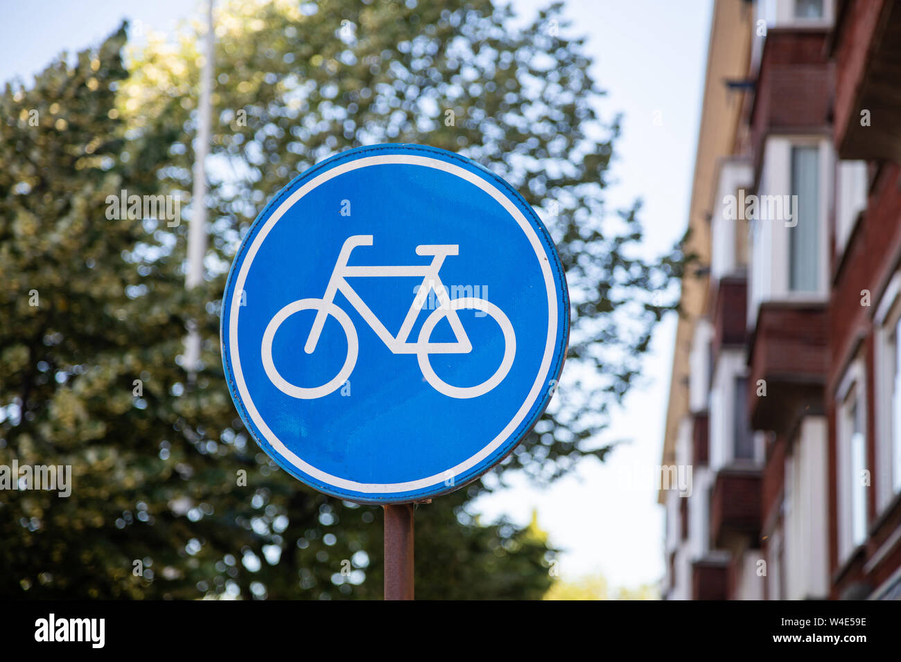 Bicycles lane sign, White bike icon on round blue color sign. Dutch ...