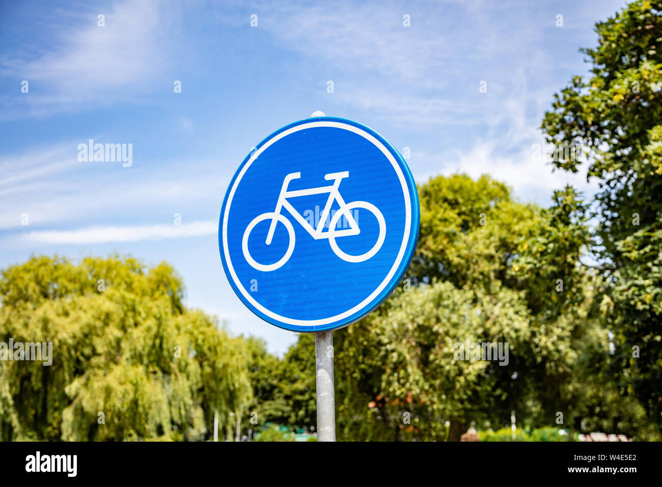 Bicycles lane sign, White bike icon on round blue color sign. Dutch ...