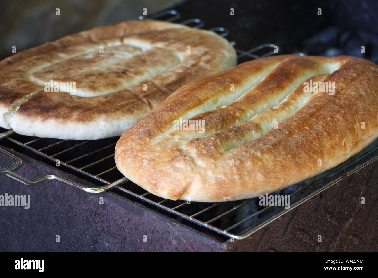 Closeup of pita bread or pita fried over an open fire or grill, concept ...