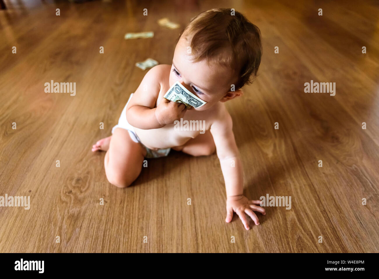 Baby happy to earn his own money, dollar bills that a father gives his ...