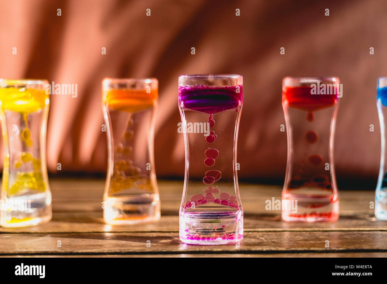 Toy with water and drops of oil colors Stock Photo - Alamy
