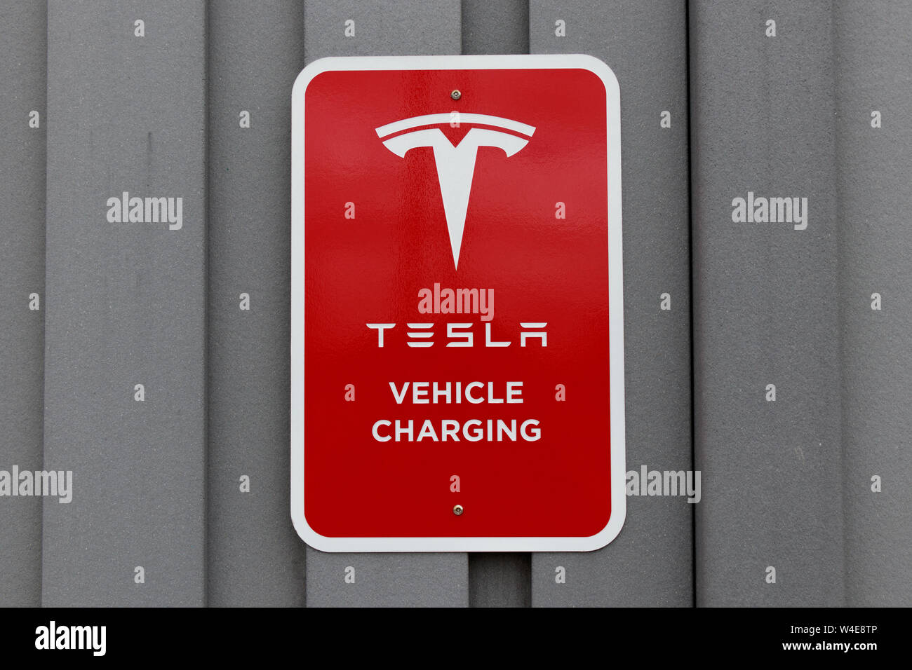 Tesla Electric Vehicle Only Sign against grey siding at CF Markville ...