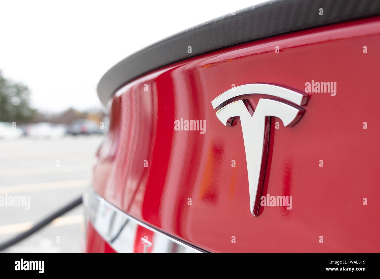 Red Tesla Model S rear badge as the vehicle is plugged-in at Tesla CF ...