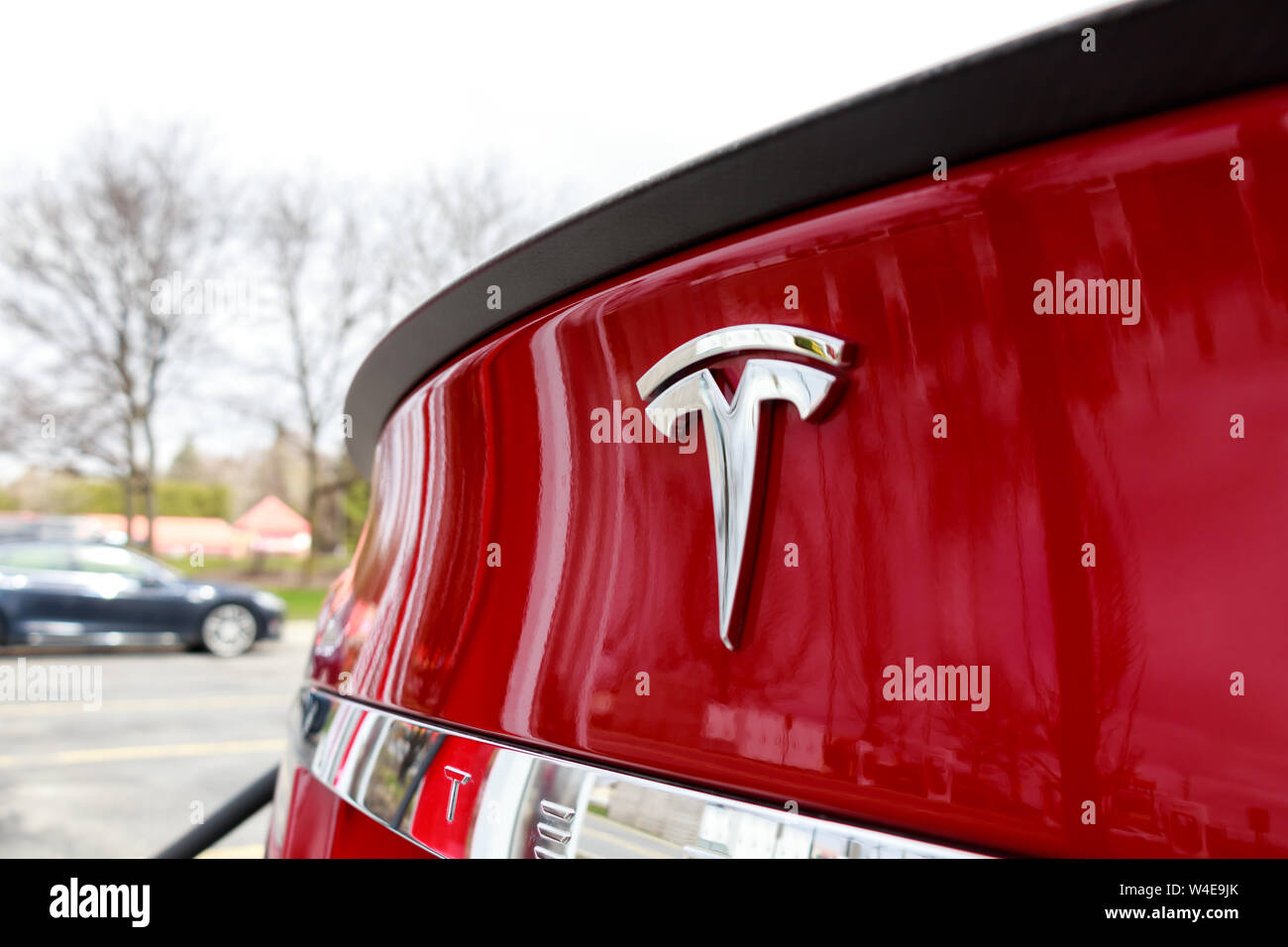 Red Tesla Model S rear badge as the vehicle is supercharged at Tesla ...