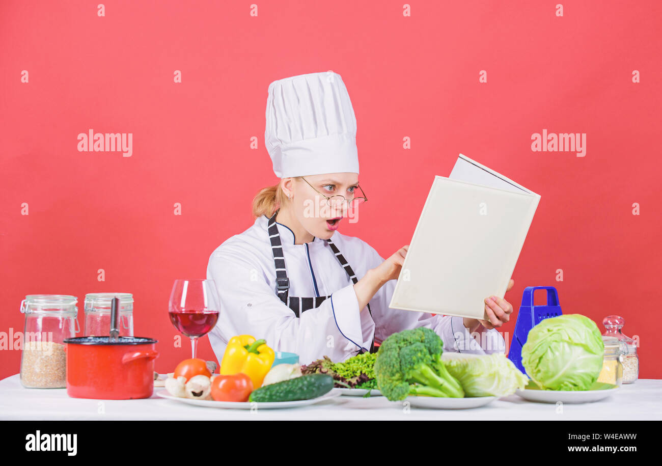 Woman chef cooking healthy food. Girl read book best culinary recipes ...
