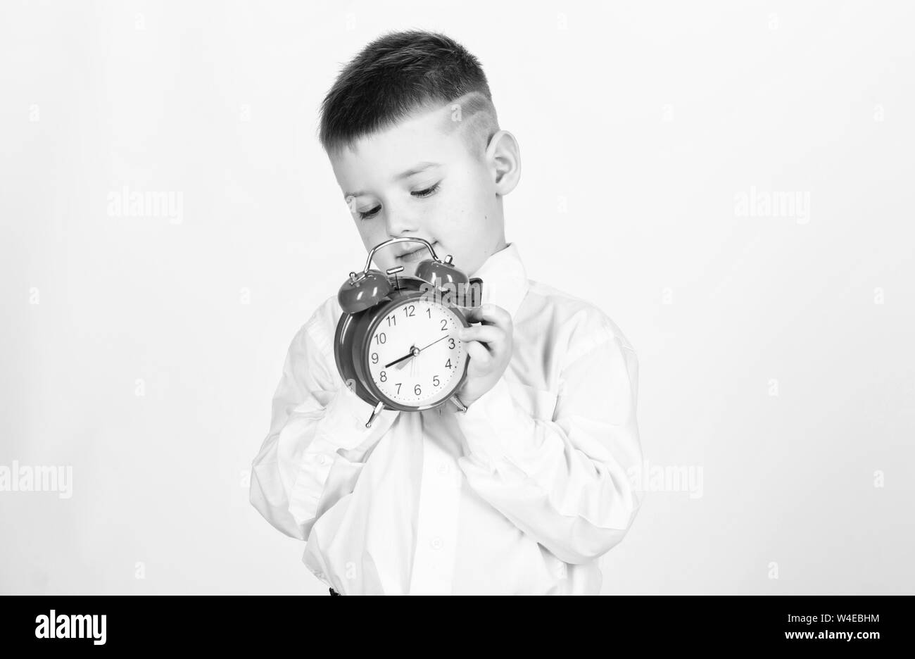 Schoolboy with alarm clock. Kid adorable boy white shirt red bow tie ...
