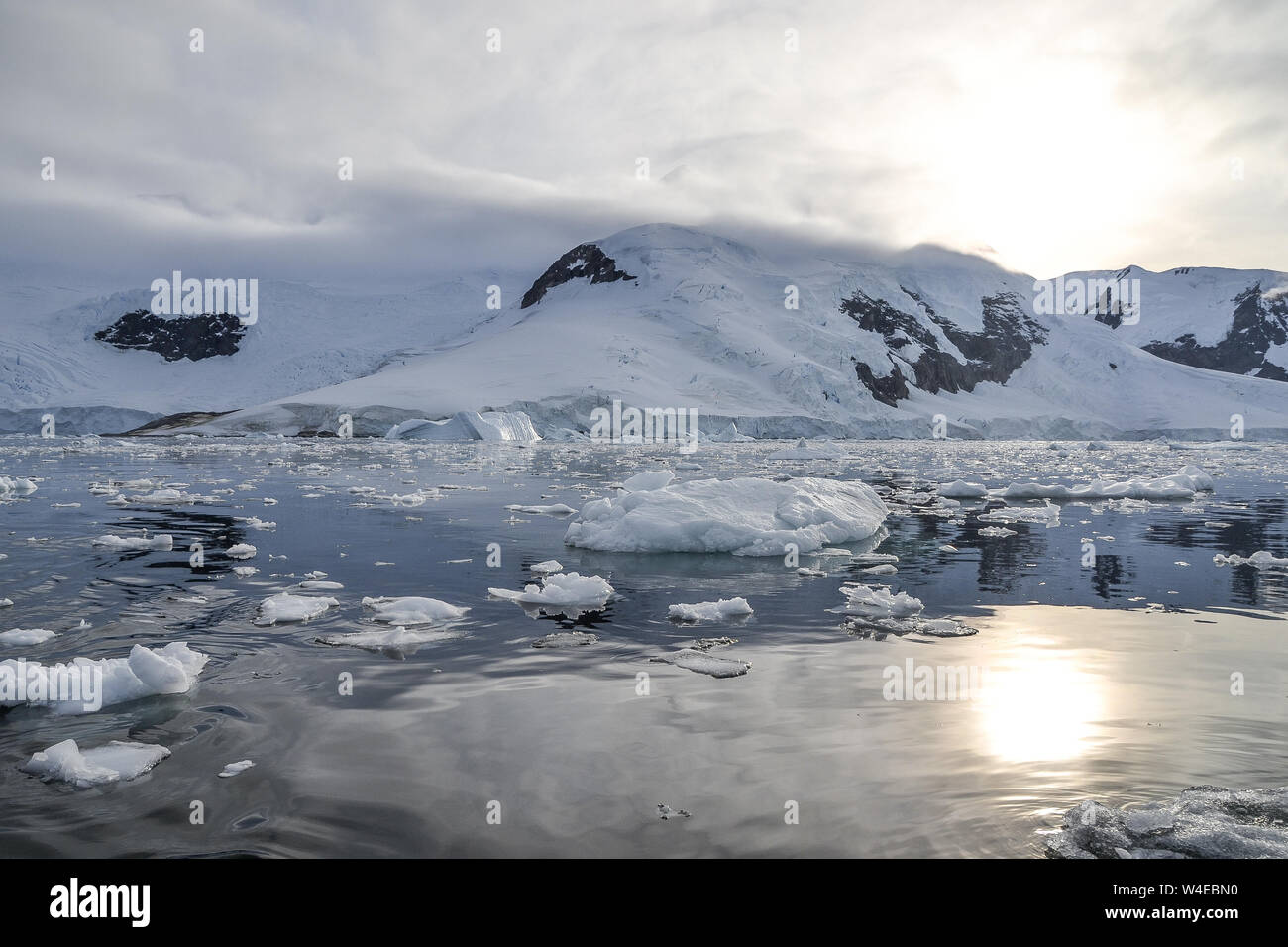 Sun setting over the mountains in Antarctica Stock Photo - Alamy
