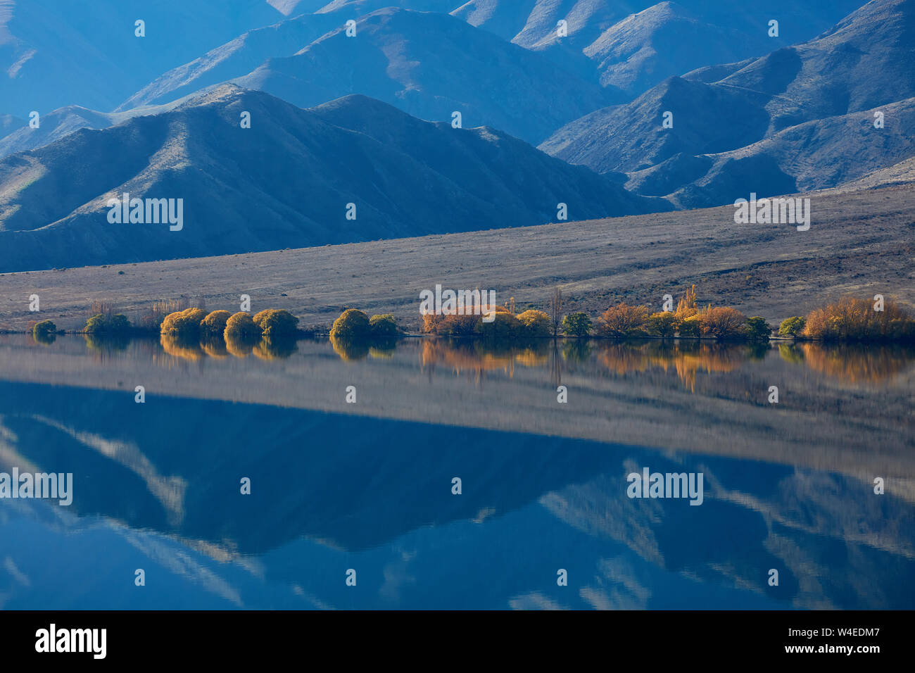 Benmore Range reflected in Lake Benmore, Waitaki Valley, North Otago ...