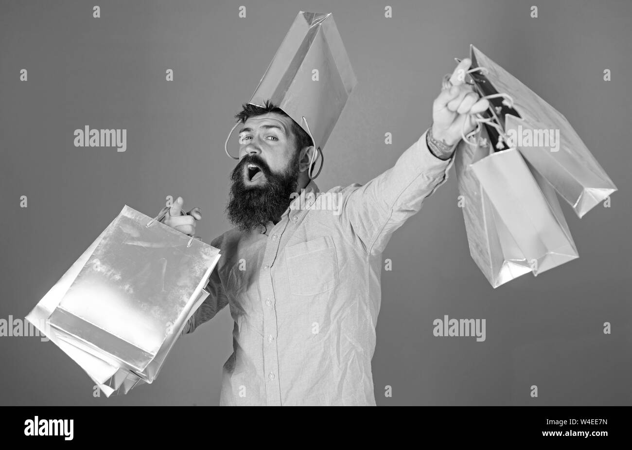 Guy shopping on sales season with discounts. Hipster on cheerful face ...