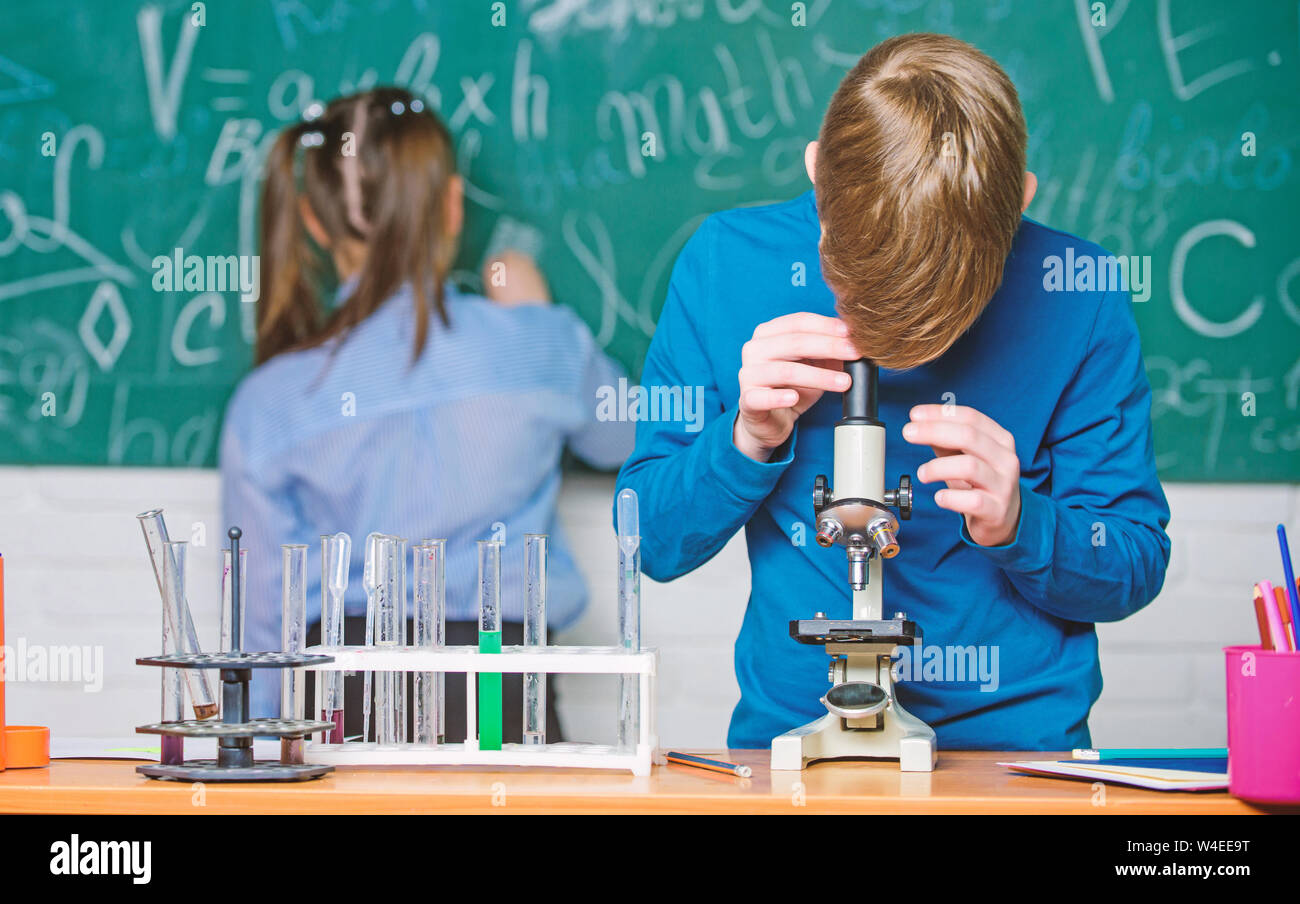 Little boy and girl in lab. biology experiments with microscope. Little ...