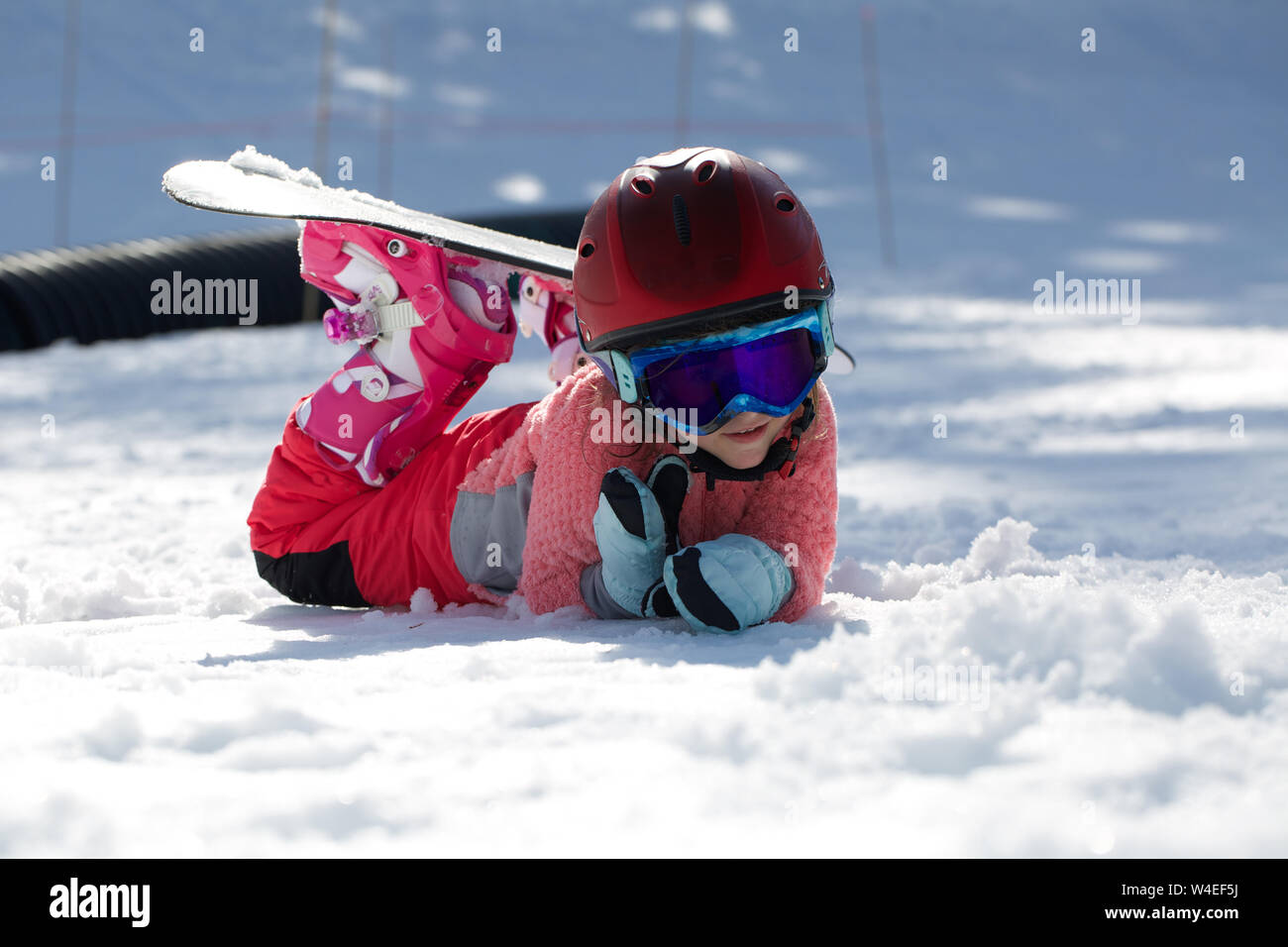 Little Cute Girl Snowboarding making a tricks at ski resort in sunny ...