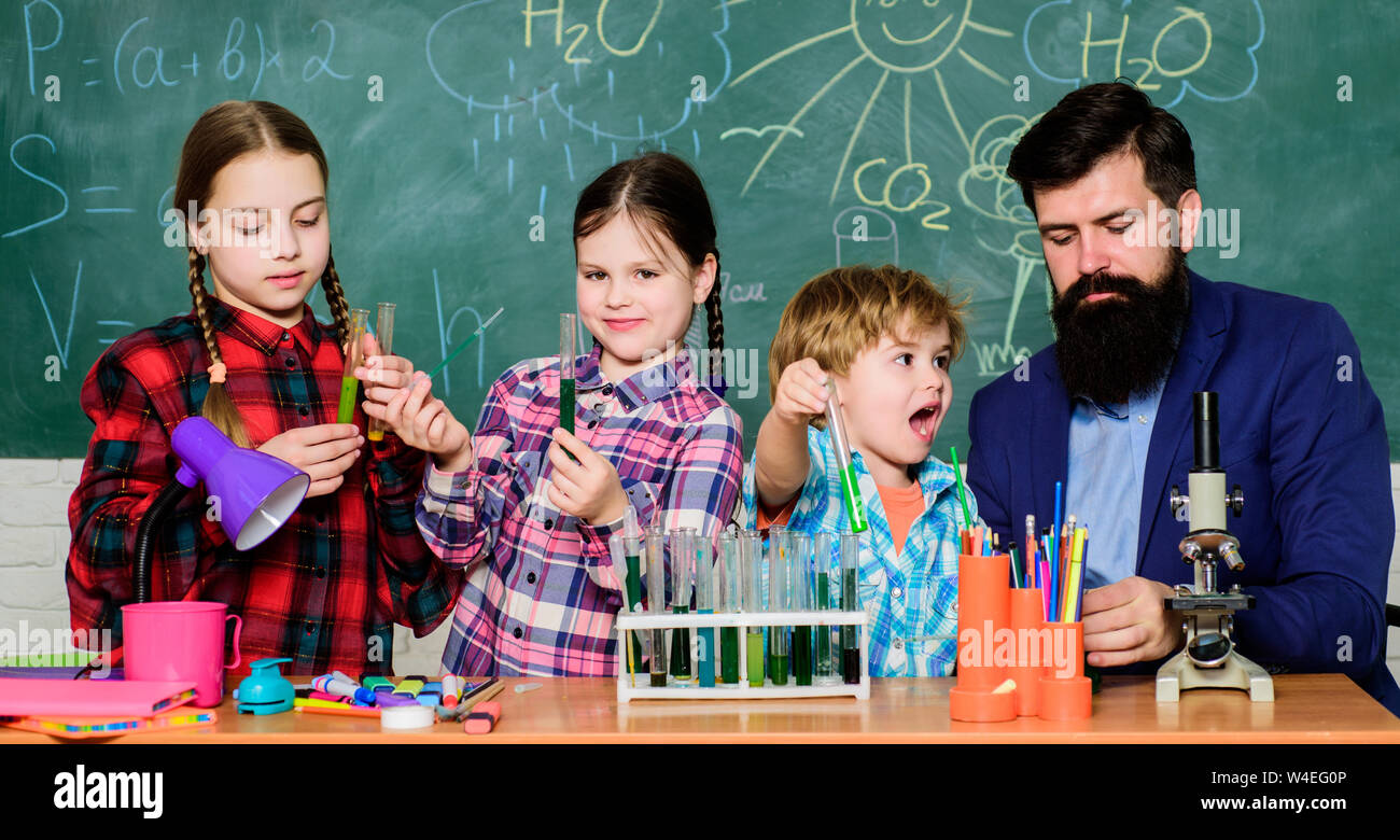 Little kids learning chemistry in school laboratory. school kids ...