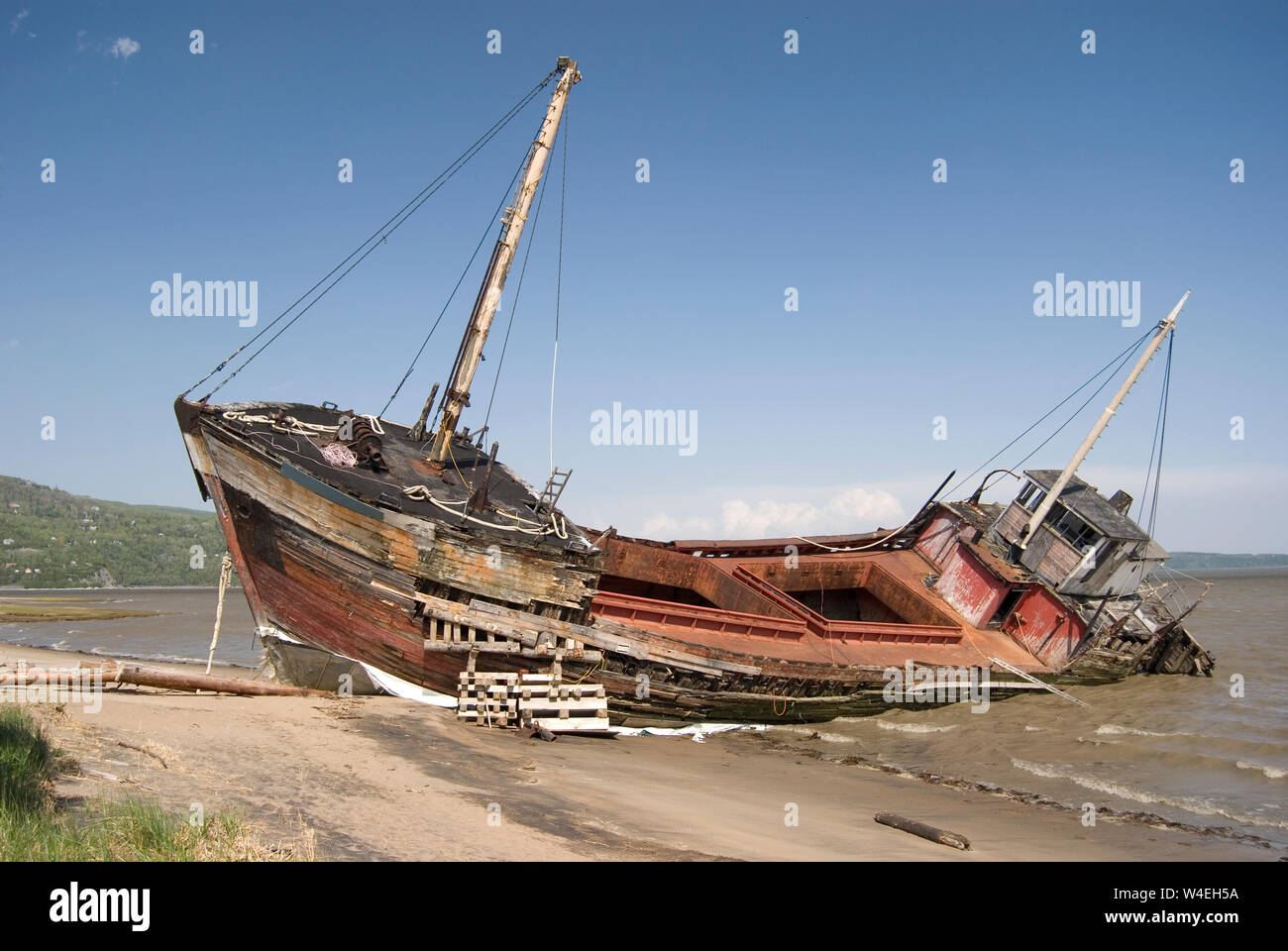 Shipwreck on a Beach in Baie St-Paul Quebec, Canada with Blue Sky Stock ...