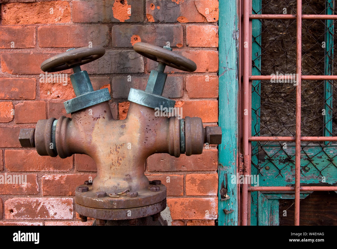 Rusted Industrial Water Pump and Brick Wall Stock Photo - Alamy