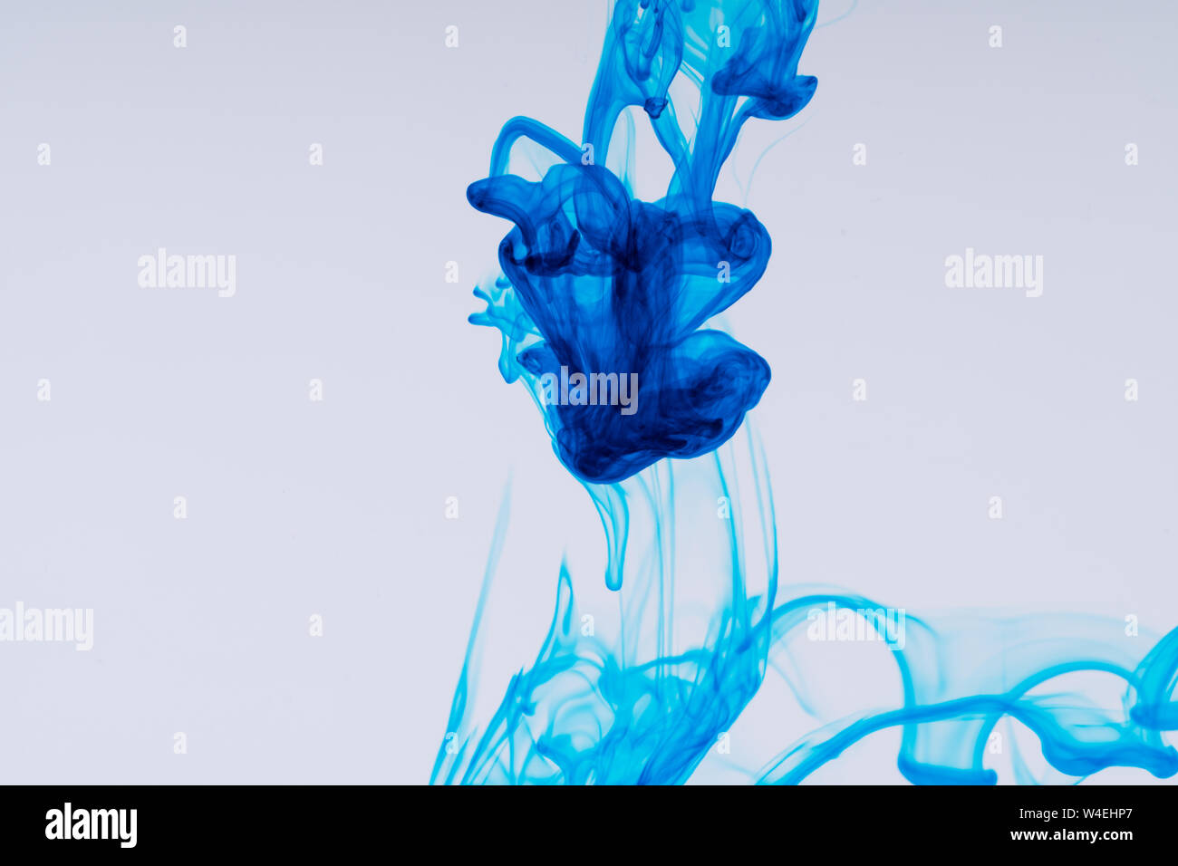 Cloud of ink in water on white background Stock Photo - Alamy
