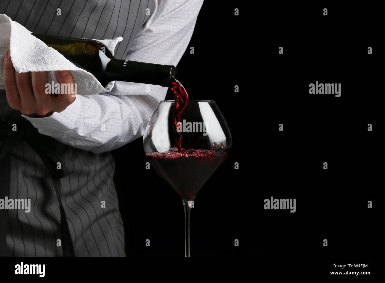 red wine pouring in wine isolated on black Stock Photo - Alamy